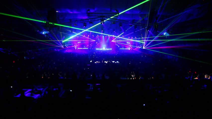 Many People At Rave Party In Large Congested Hall With Color