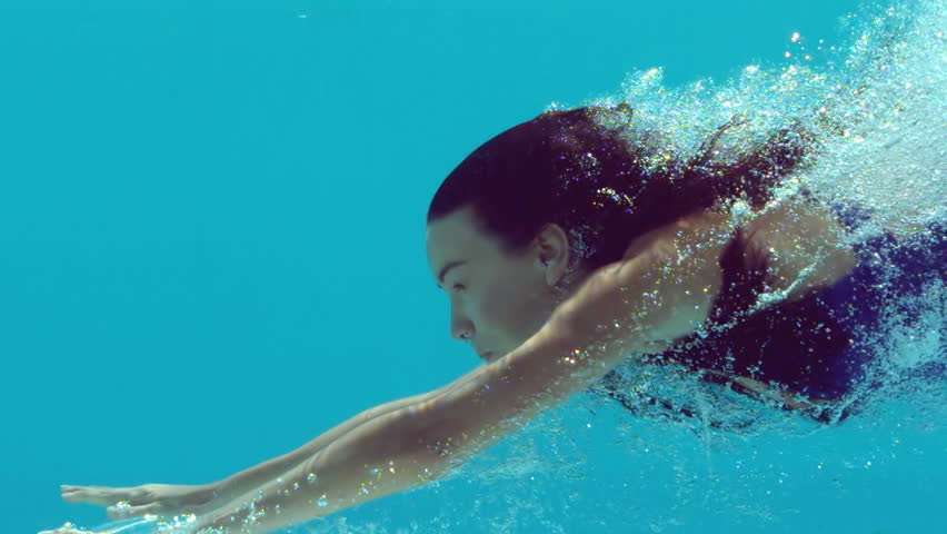 Beautiful Woman In A Pink Bikini Diving In And Swimming Underwater