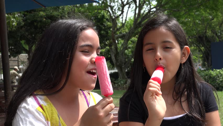 Young Girls Eating Popsicles Stock Footage Video 13038101 - Shutterstock