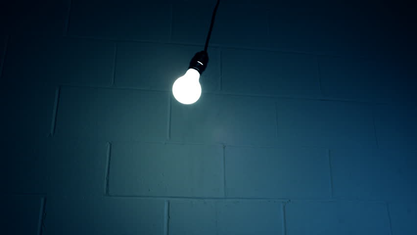 Light Bulb Swaying Against Wall In Dark Room Stock Footage Video ...