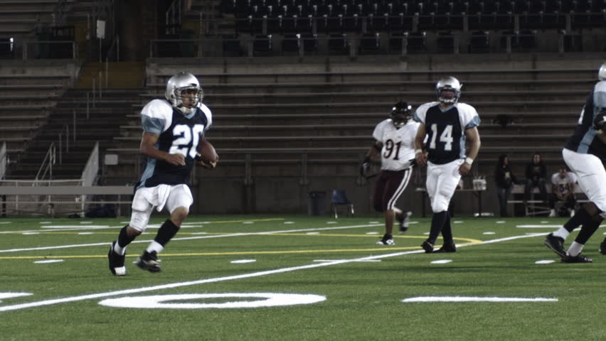 A Football Player Jumps Over A Tackler Stock Footage Video 4706186 ...