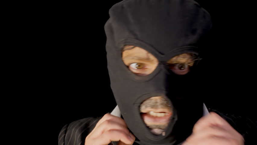 A Masked Man, Robber, Criminal, Appears Running From Deep Darkness ...