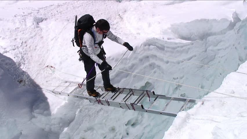 MT. EVEREST - CIRCA 2010: Climber On Ladder Looking Down At Crevasse ...