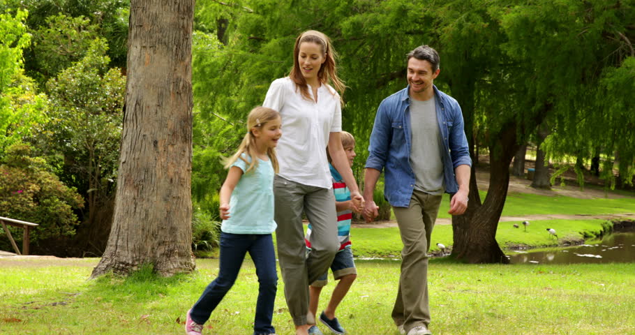 Happy Family Walking In The Park Together On A Sunny Day Stock Footage ...