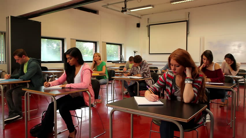 Quiet Students Sitting In A Classroom And Taking Notes In A College ...