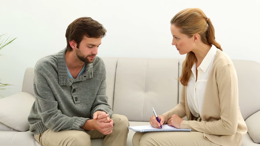 Young Man Speaking To A Therapist While She Is Taking Notes Stock ...