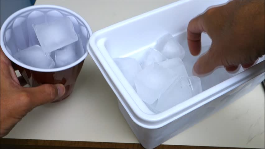 Person Putting Ice Cubes In Cup To Make Cold Beverage Stock Footage ...